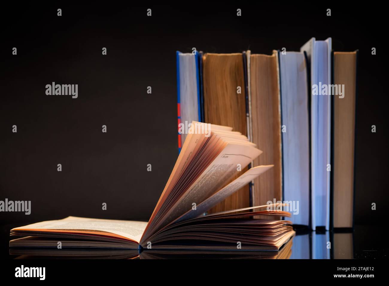 open book for reading and a stack of books Stock Photo - Alamy
