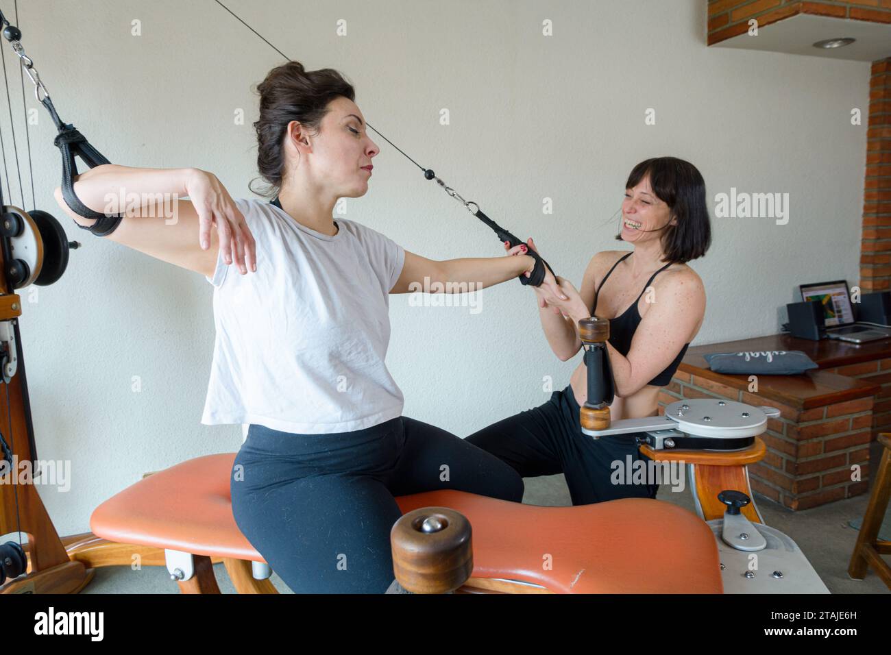 Caucasian female trainer standing assisting her student during training ...