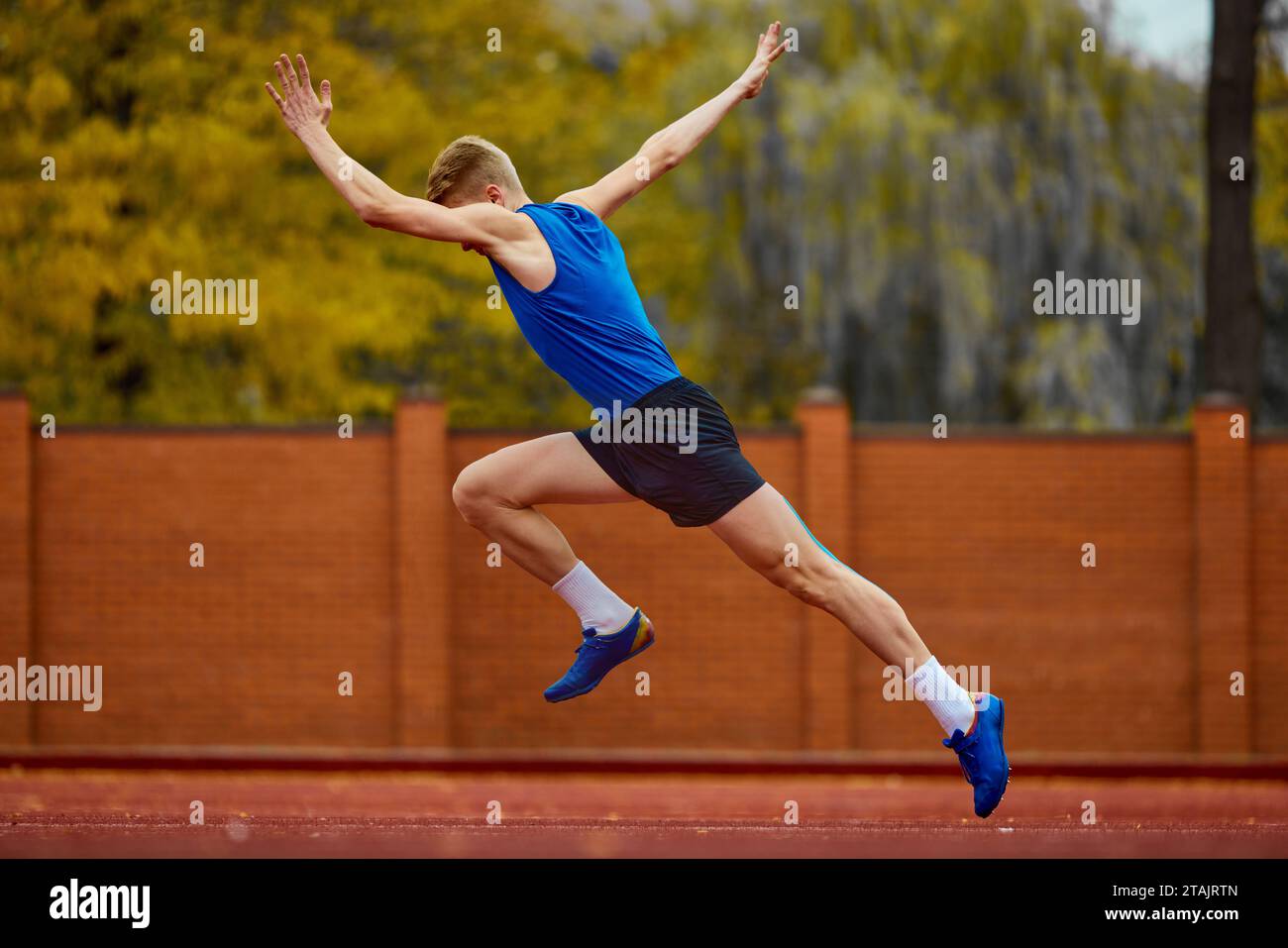 Athlete's controlled sprint before liftoff. Side view full length ...