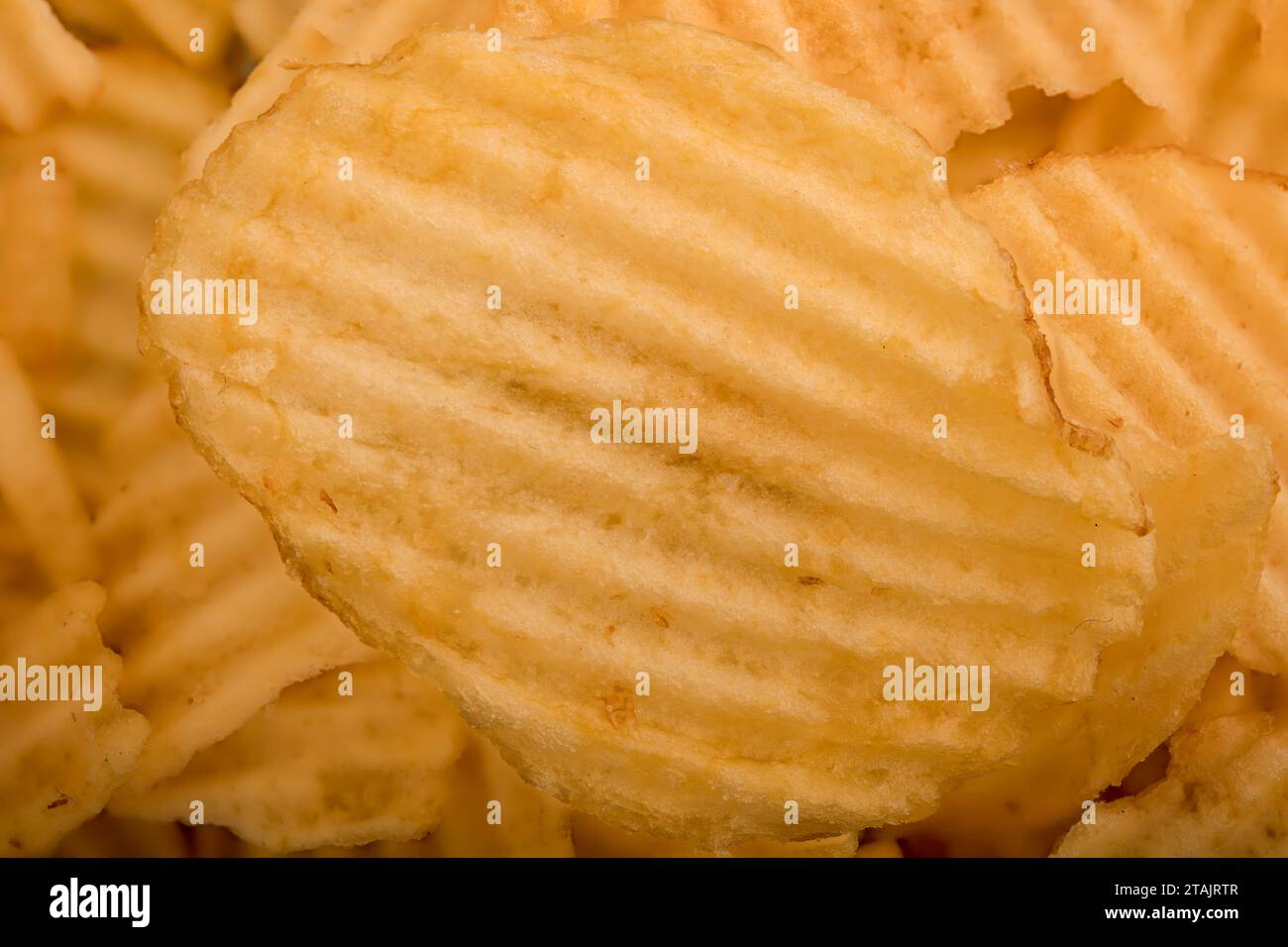 Close up snack food still life of crinkle cut crisps Stock Photo - Alamy