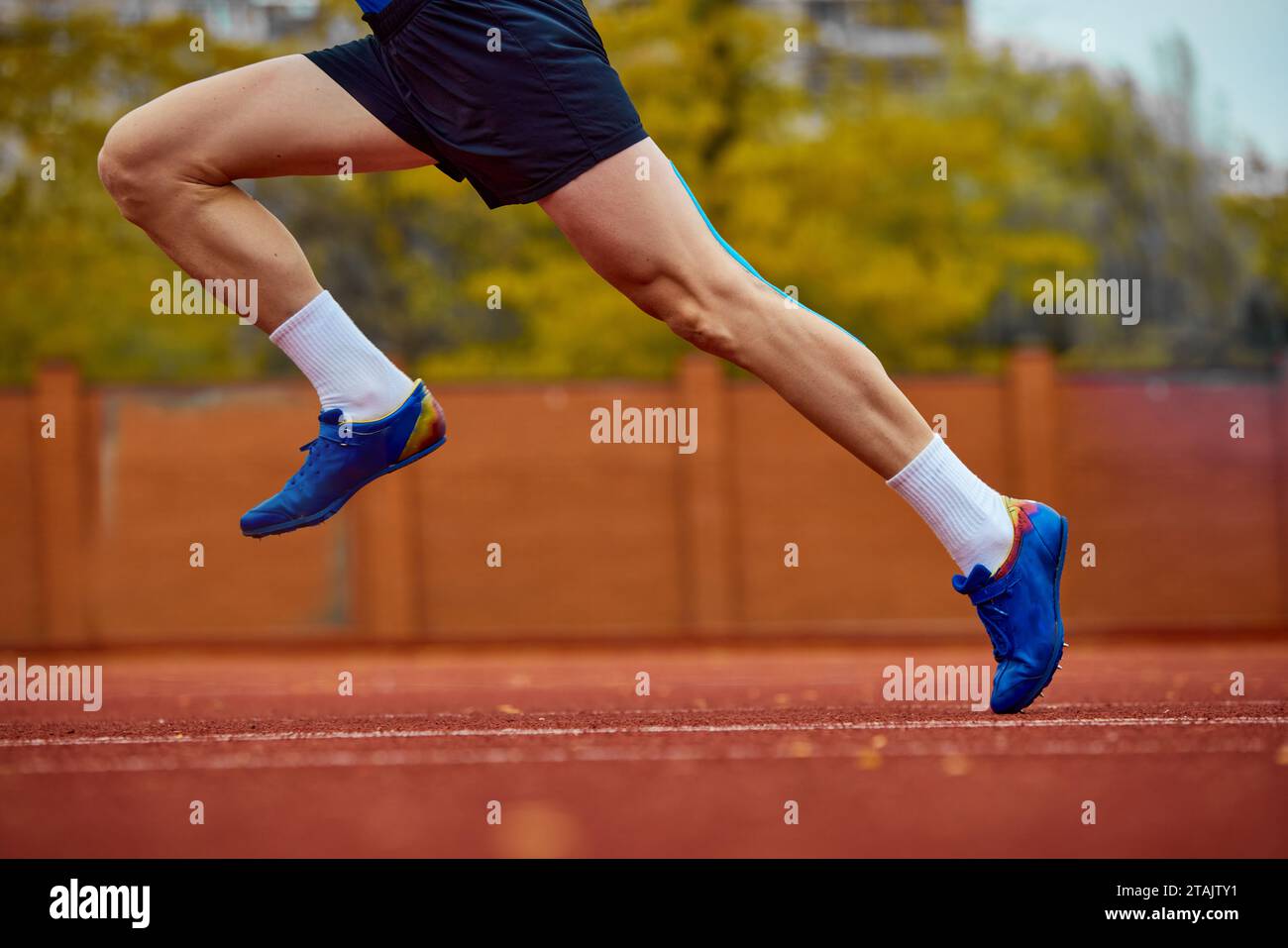 Focused sprinter on the verge of takeoff. Side view cropped photo of ...