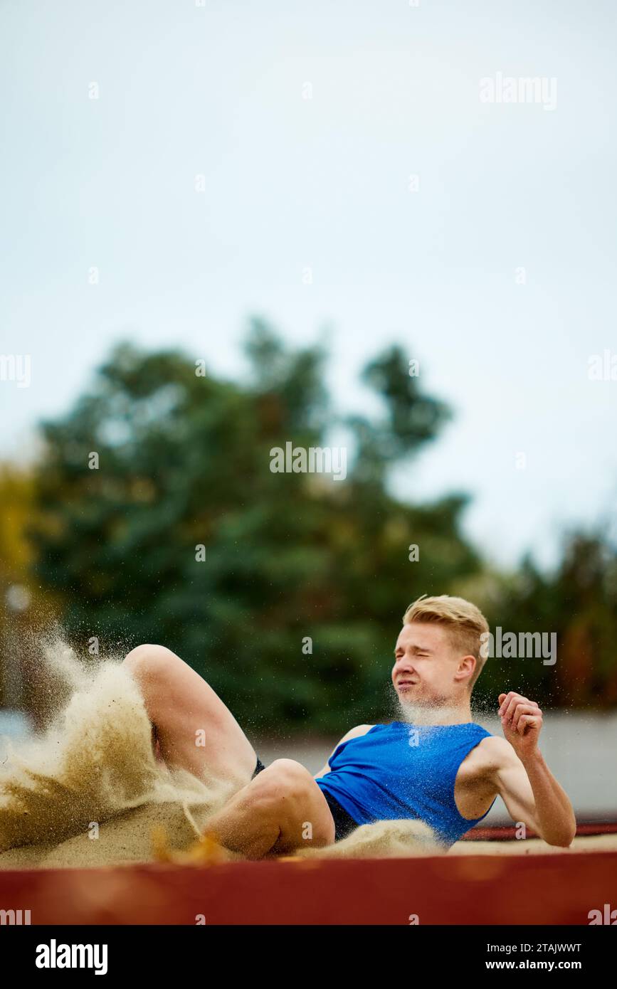 Professional, skilled sportsman landing in sand court of impressive ...