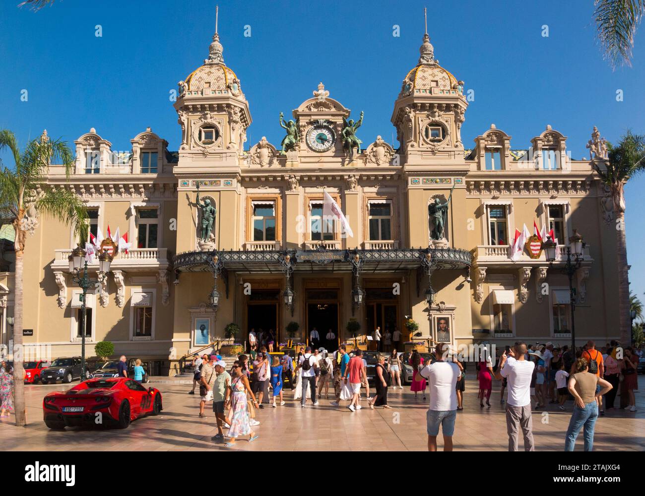 Expensive cars, people viewing them and the exterior of Monte Carlo ...
