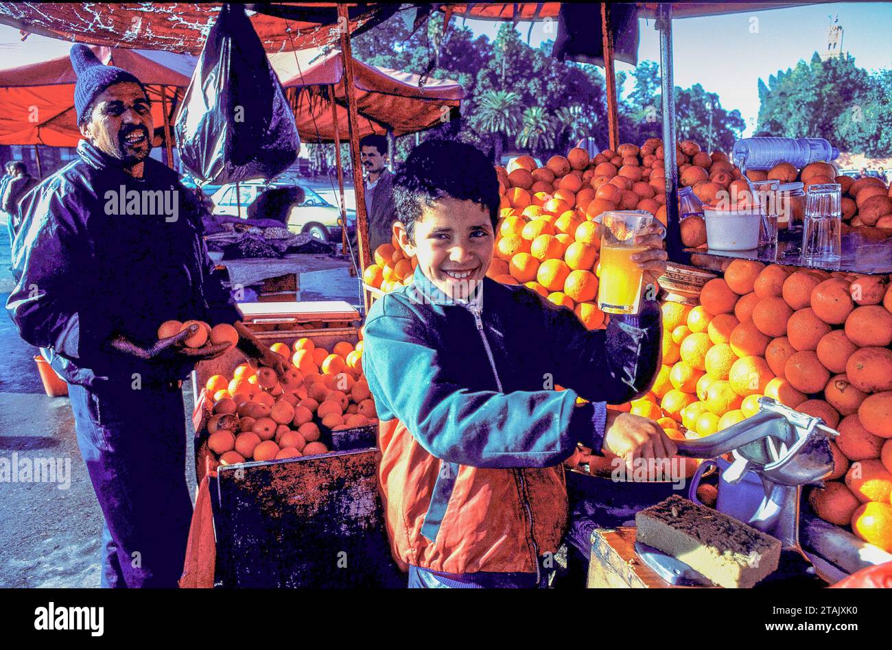 Morocco, Marrakesh - young boy is selling oranges, juice and water from ...