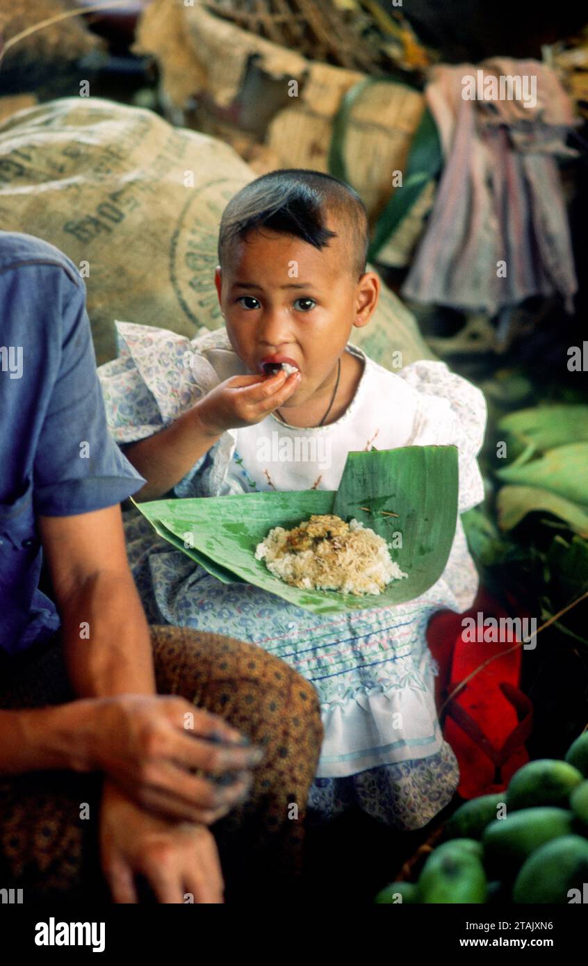 Child eating rice indonesia hi-res stock photography and images - Alamy
