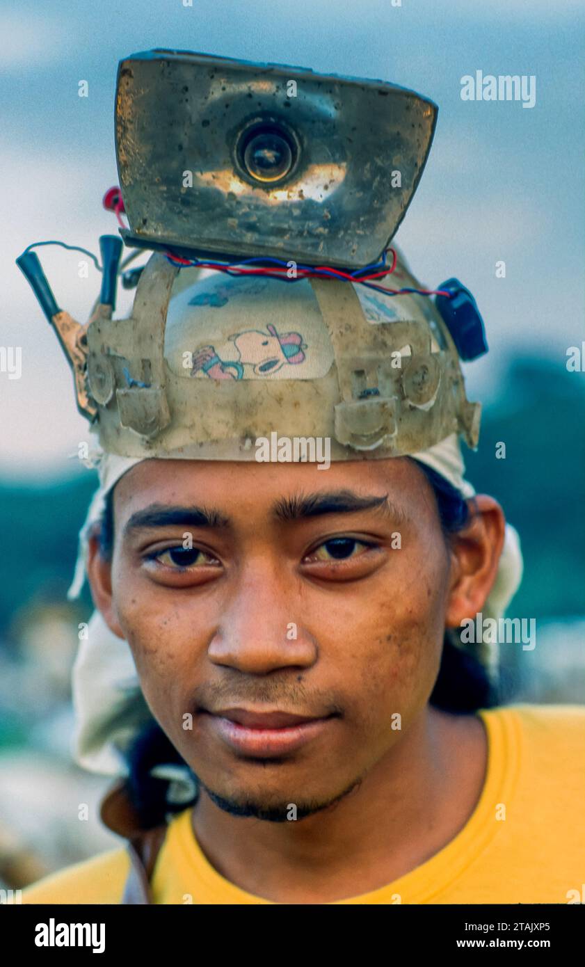 Indonesia, Jakarta. Portrait of a man with a helmet made of selected ...