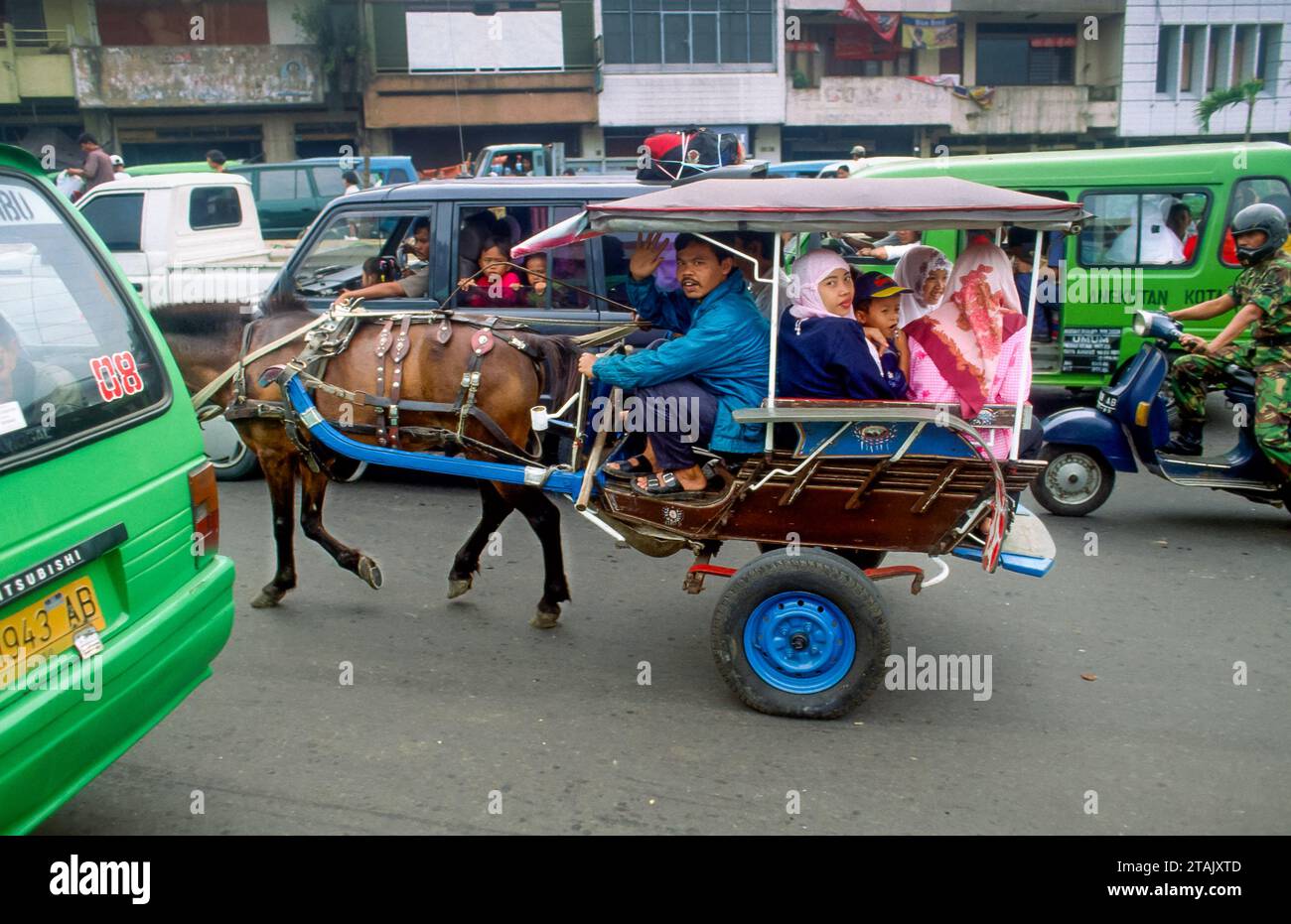 Indonesia, Bandung. Horsecart transporting islamic women Stock Photo ...