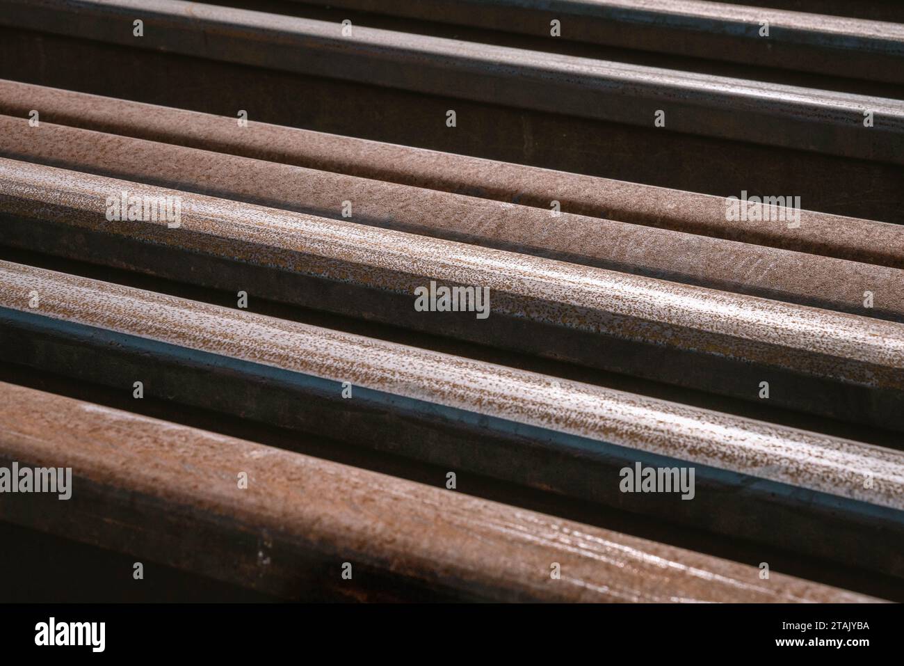 Many used rusty rails of different length stored at a ground for old ...