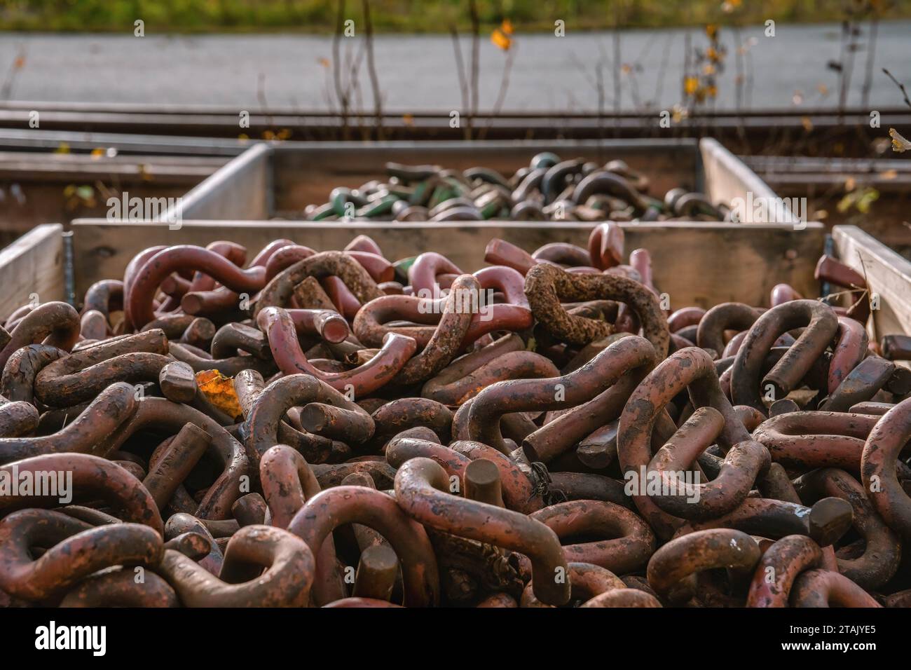 Many used old rusty railway rails fasteners in tree box, close up photo ...