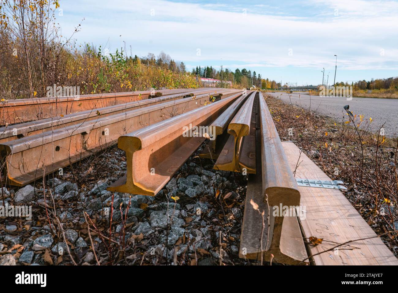 Many used rusty rails of different length stored at a side of railway ...