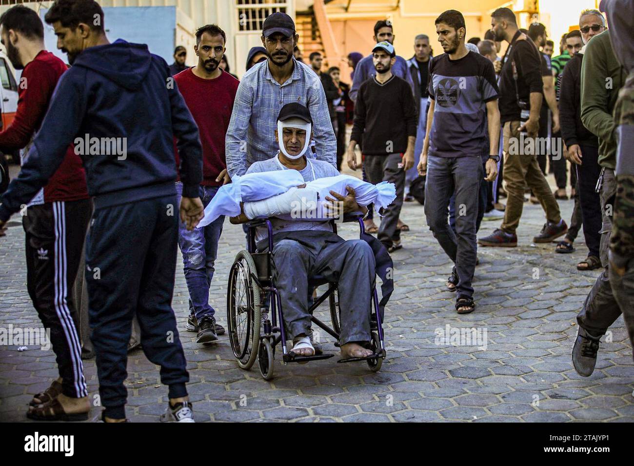 A Palestinian father carries his child who was killed during an Israeli ...