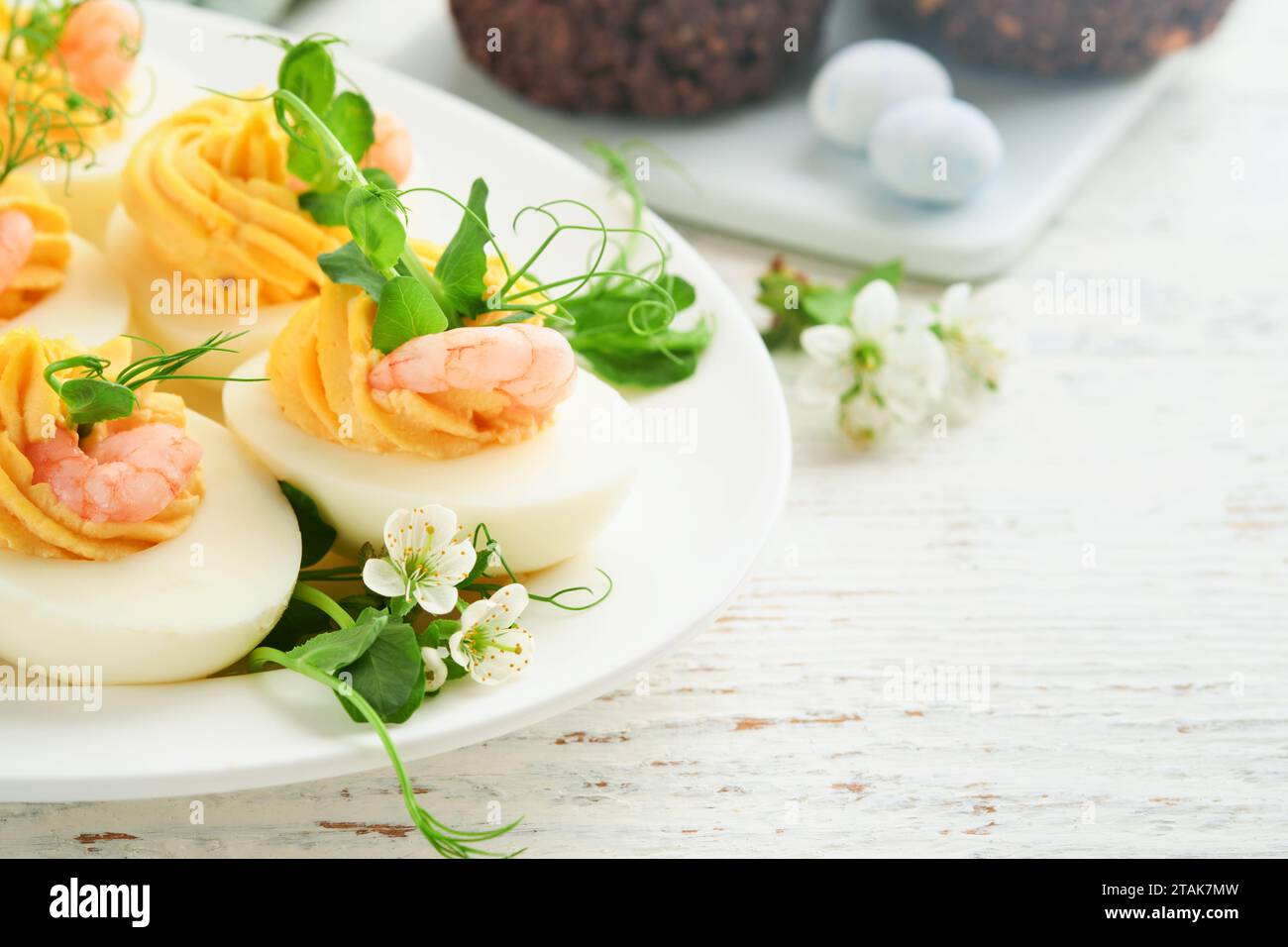 Stuffed or deviled eggs yolk, shrimp, pea microgreens with paprika for ...