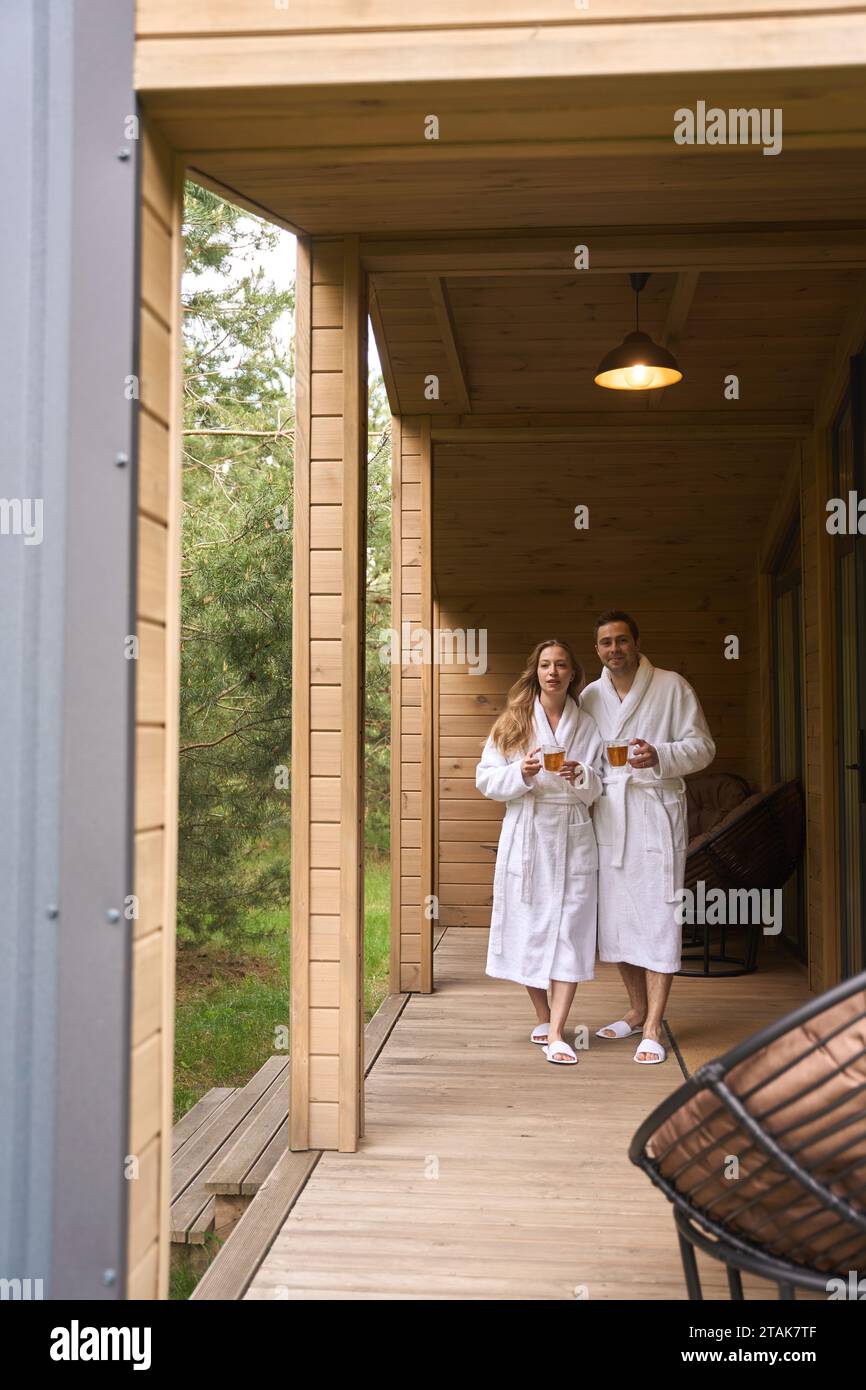 Lovely couple having morning walk on porch Stock Photo - Alamy