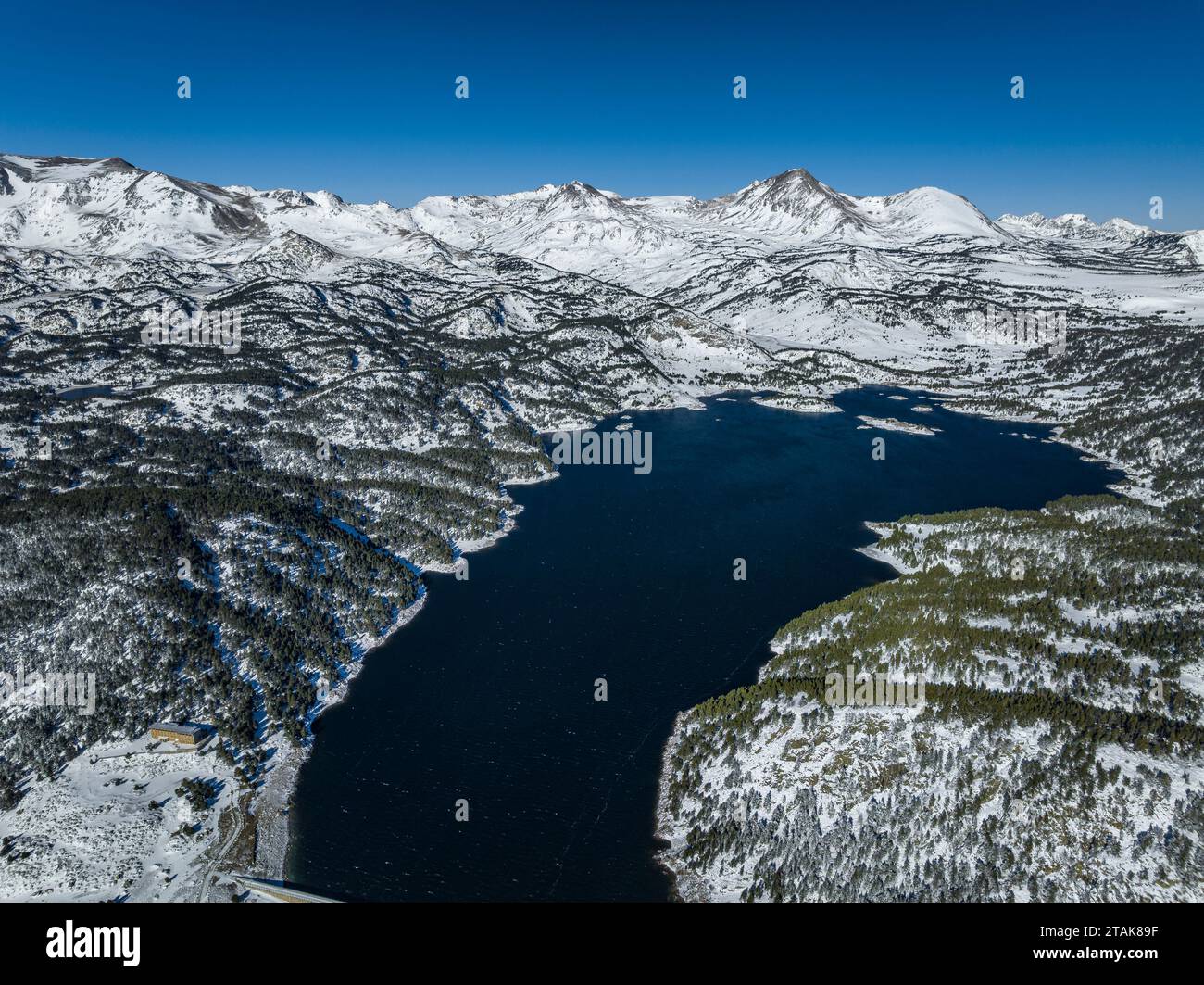 Aerial view of the Bouillouses lake after a snowfall in early winter ...