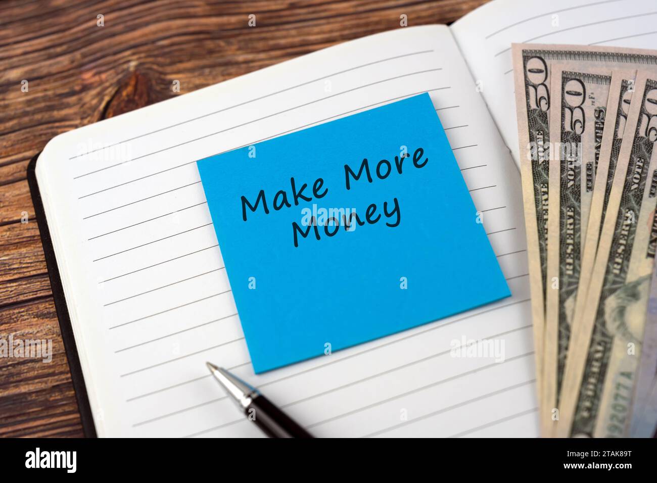Make more money text on adhesive note Stock Photo - Alamy