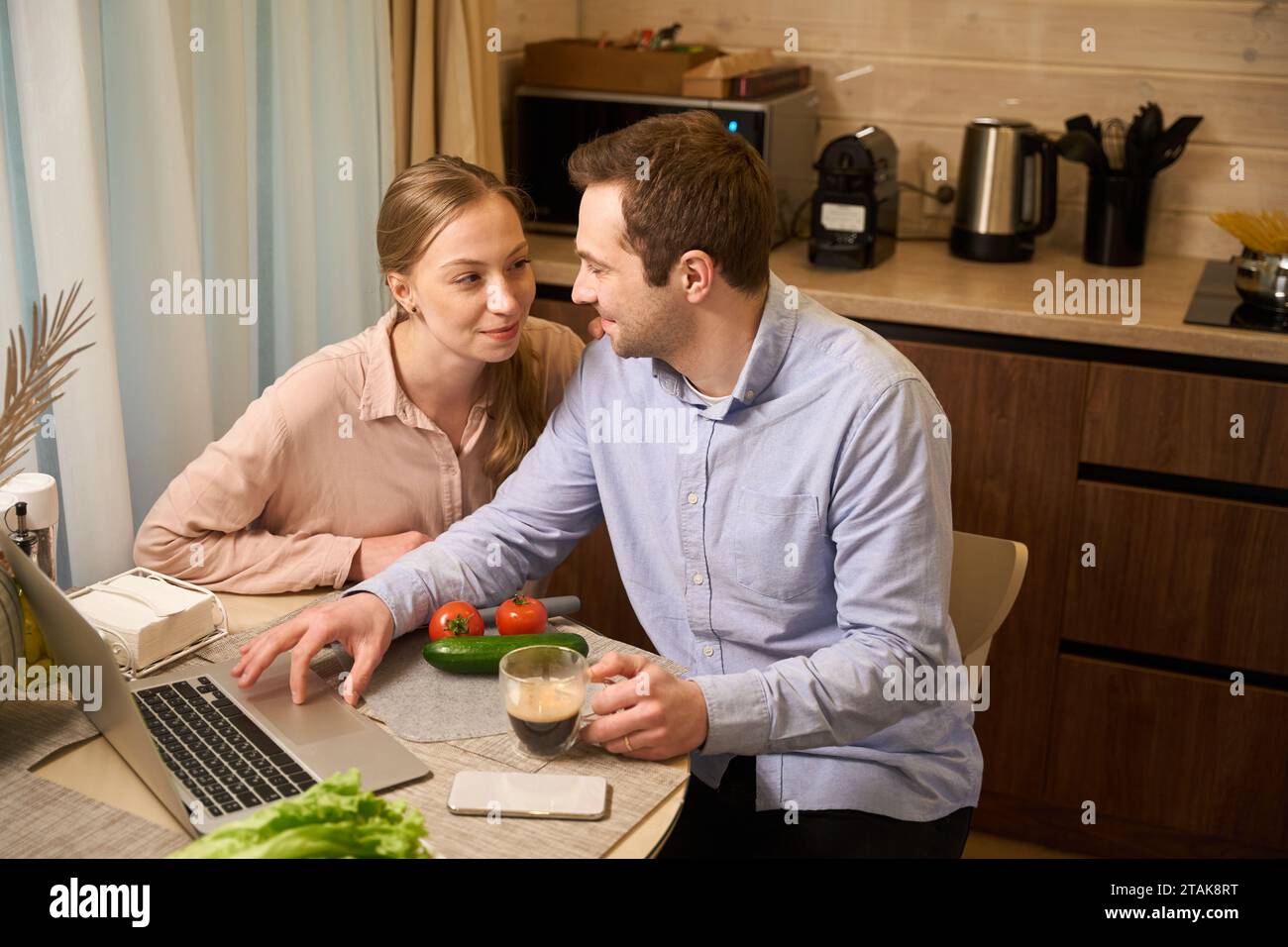 Cute couple having coffee break at home office Stock Photo - Alamy