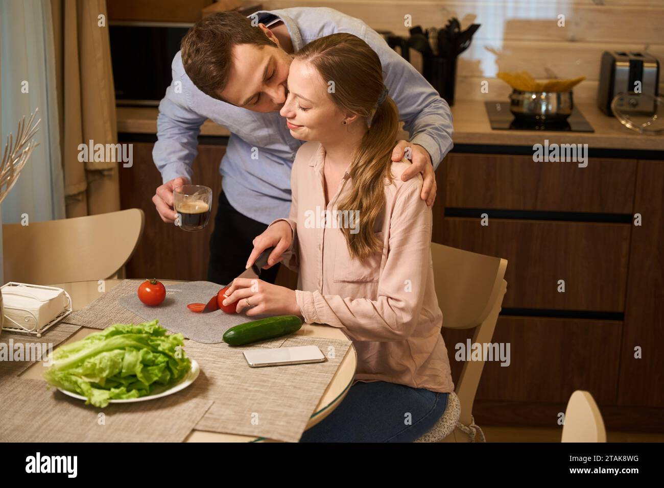 Lovely romantic couple cooking together in kitchen Stock Photo - Alamy