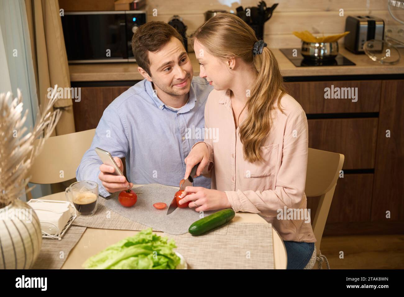 Young romantic couple cooking together in kitchen Stock Photo - Alamy