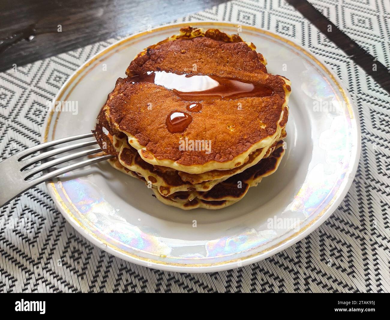 Homemade pancakes stacked on top of each other, with a little bit of ...