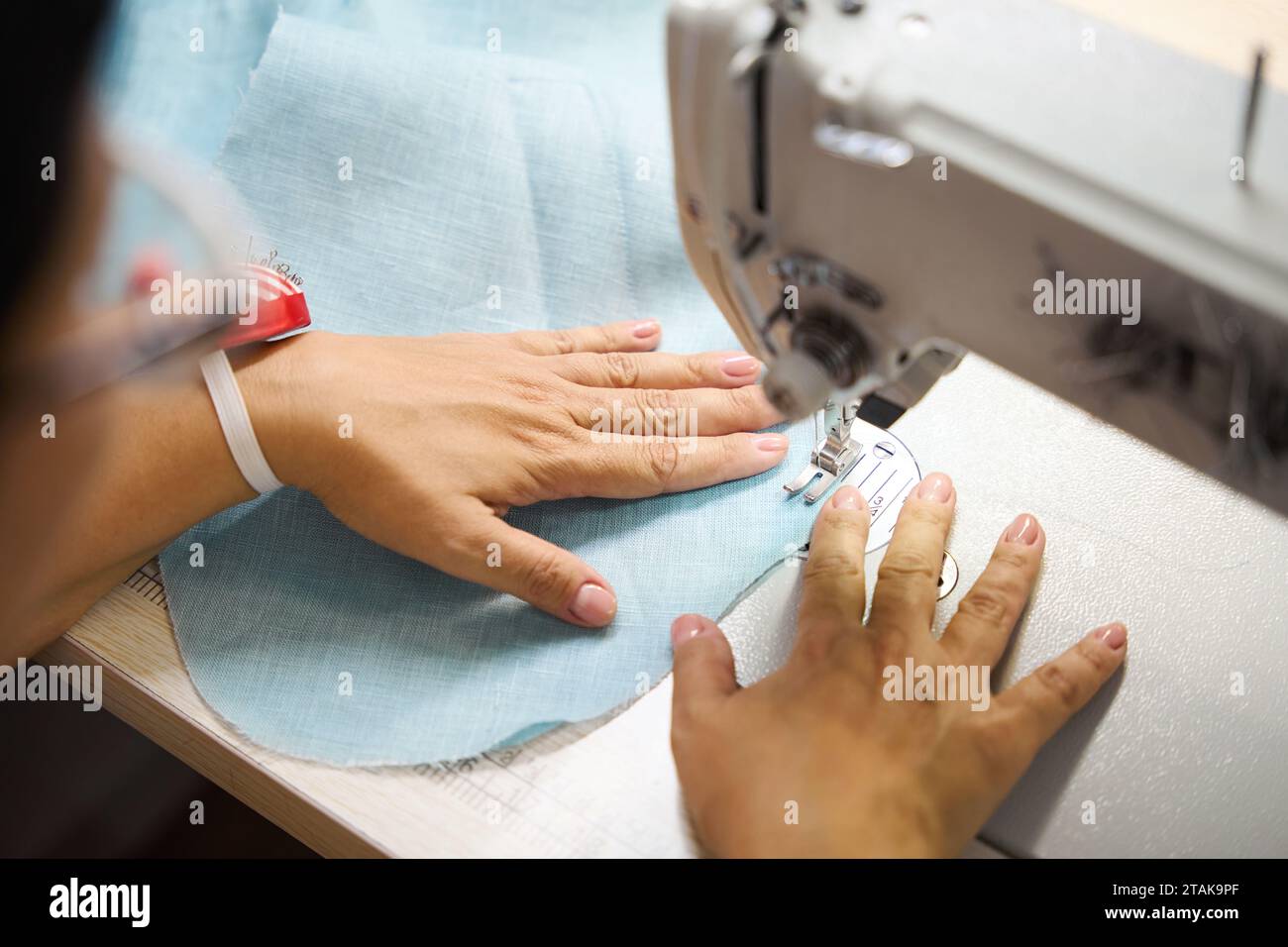 Dressmaker sews a dress on a sewing machine Stock Photo - Alamy