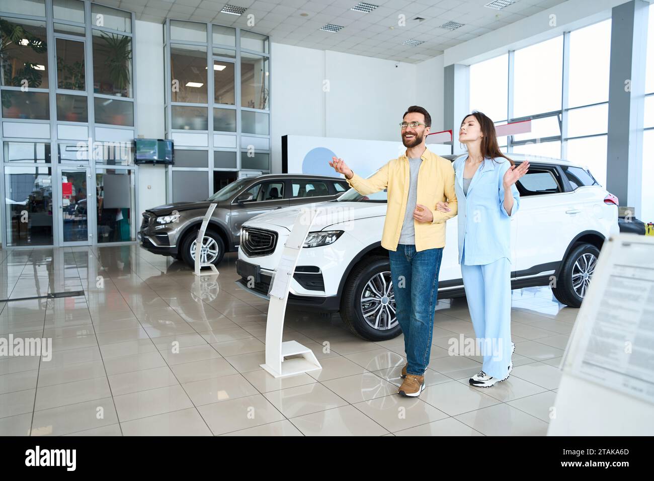 Photo of loving couple in car dealership Stock Photo - Alamy