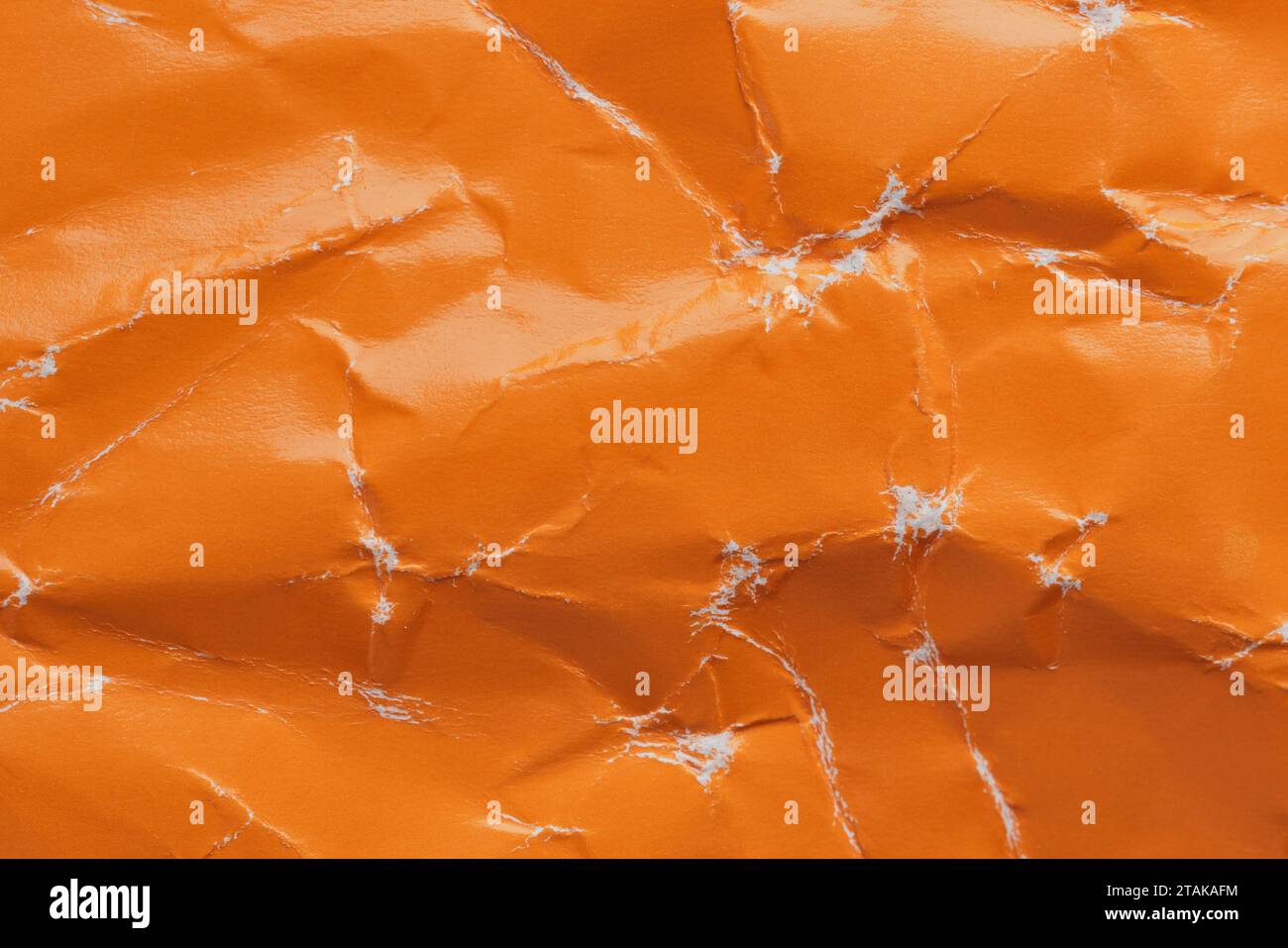 Orange crumpled paper background with folds texture Stock Photo - Alamy