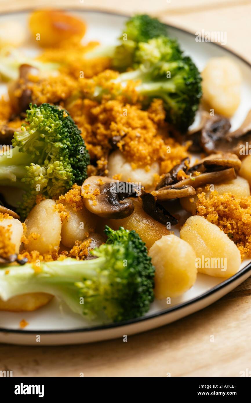 Gnocchi with Mushrooms Broccoli and Spicy Bread Crumbs Stock Photo - Alamy