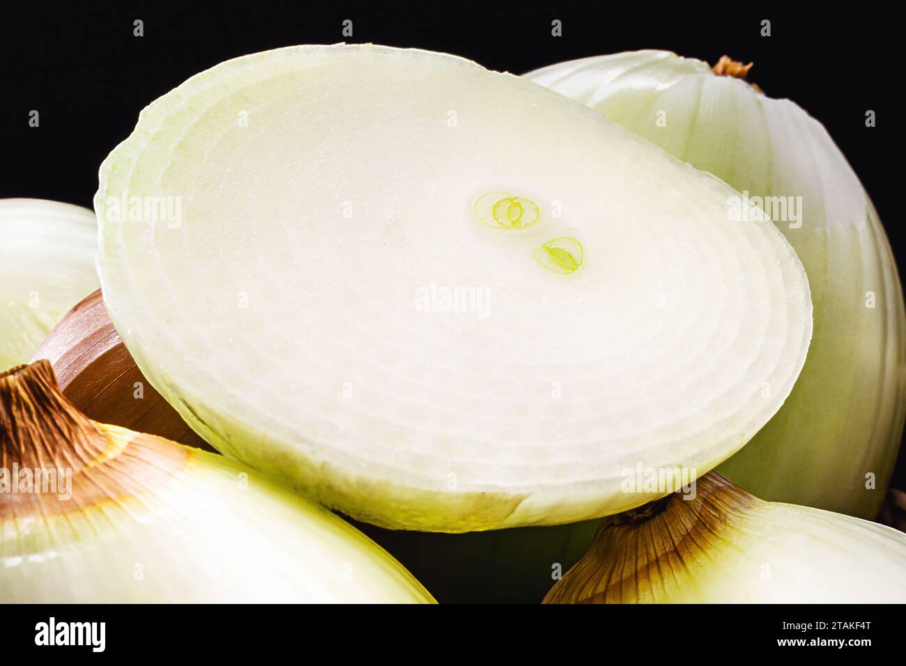 onions black background, onion cut in half, spot focus, culinary ...