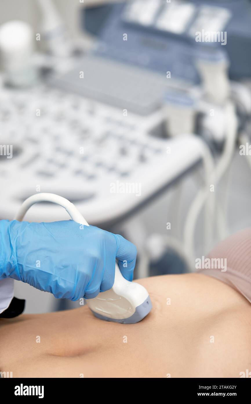 Female doctor gives the patient a female abdominal ultrasound ...