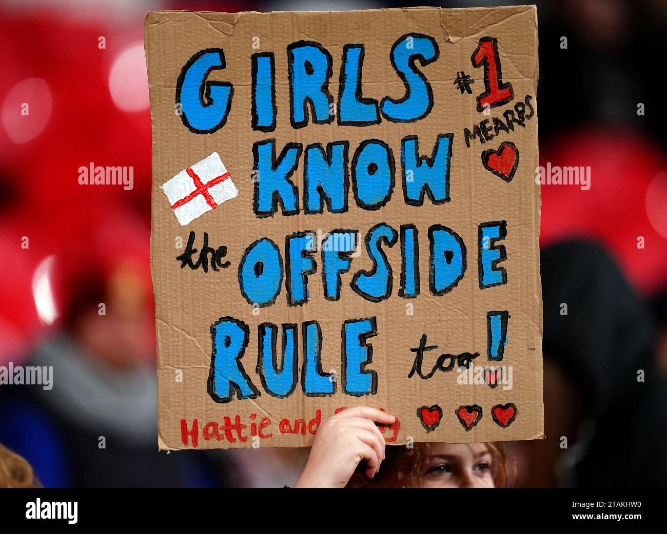 Fans hold up a sign which reads Girls know the offside rule during the ...