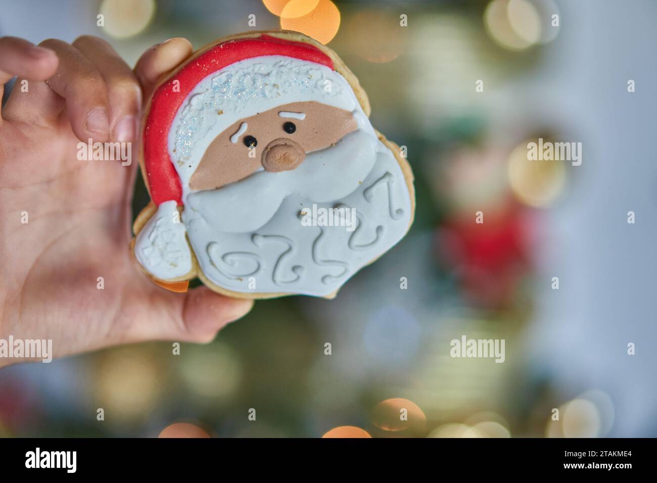 Santa Claus face Christmas sugar cookie, isolated on blurred lights ...