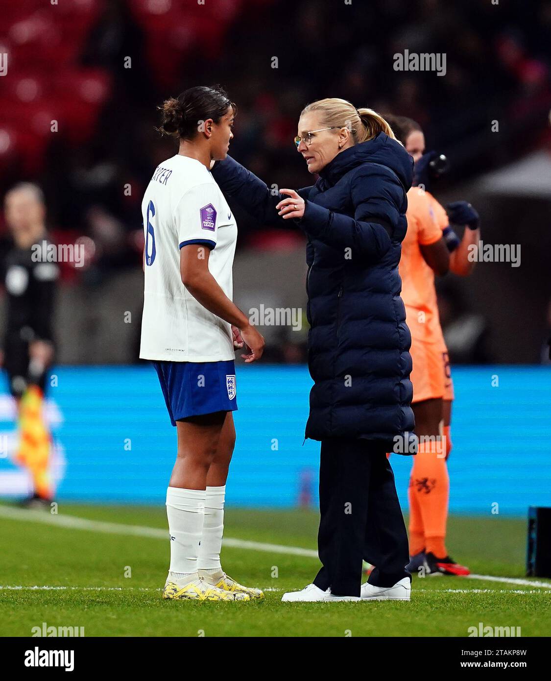 England head coach Sarina Wiegman speaks to Jess Carter during the UEFA ...