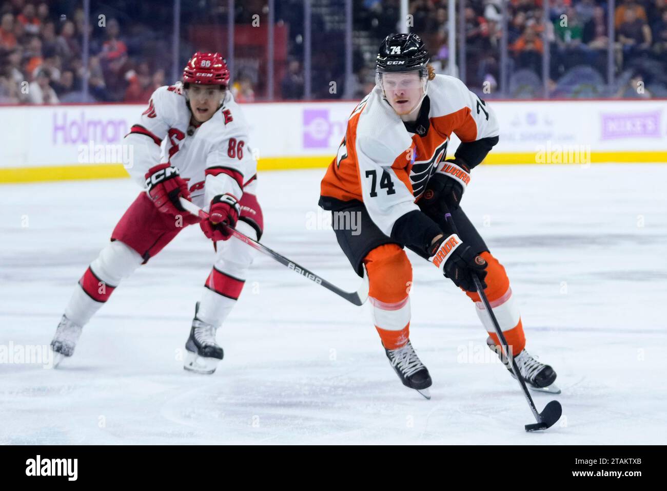 Philadelphia Flyers' Owen Tippett, right, tries to get past Carolina ...