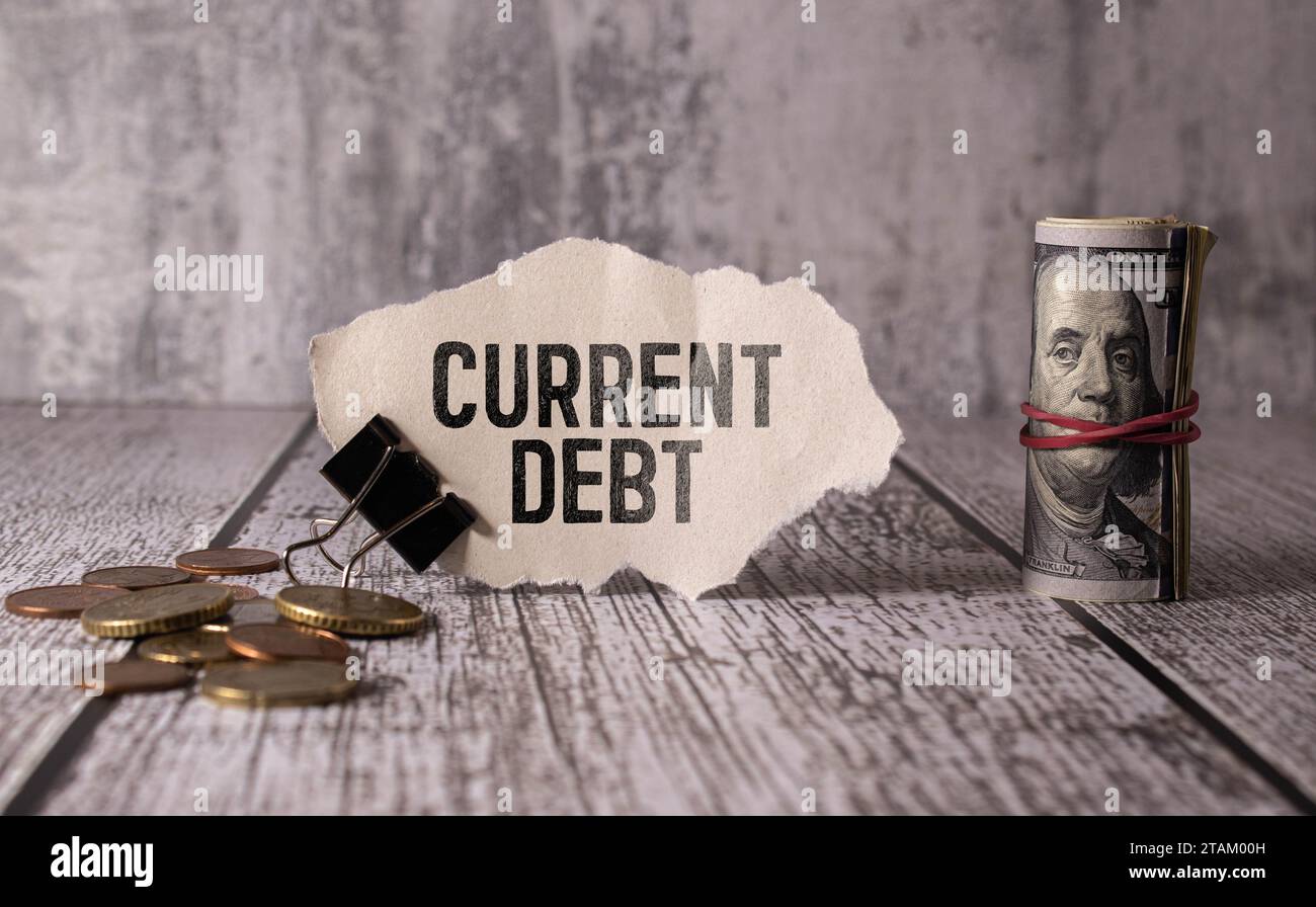 Text CURRENT RATIO on white paper sheet and marker on businessman hand on the diagram. Business ...