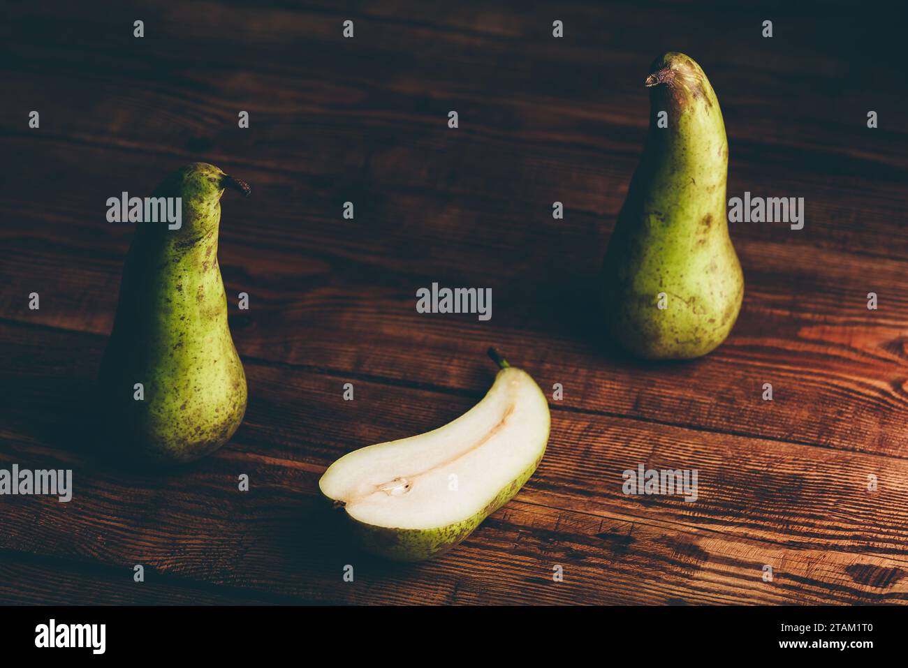 Still Life with Two Whole Conference Pears and One Halved Stock Photo ...