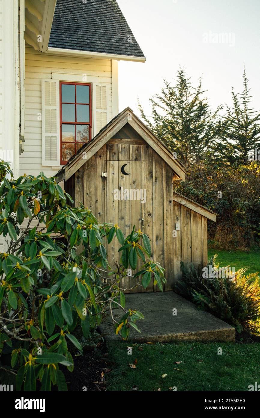 outhouse with moon cutout symbol by old building Stock Photo - Alamy