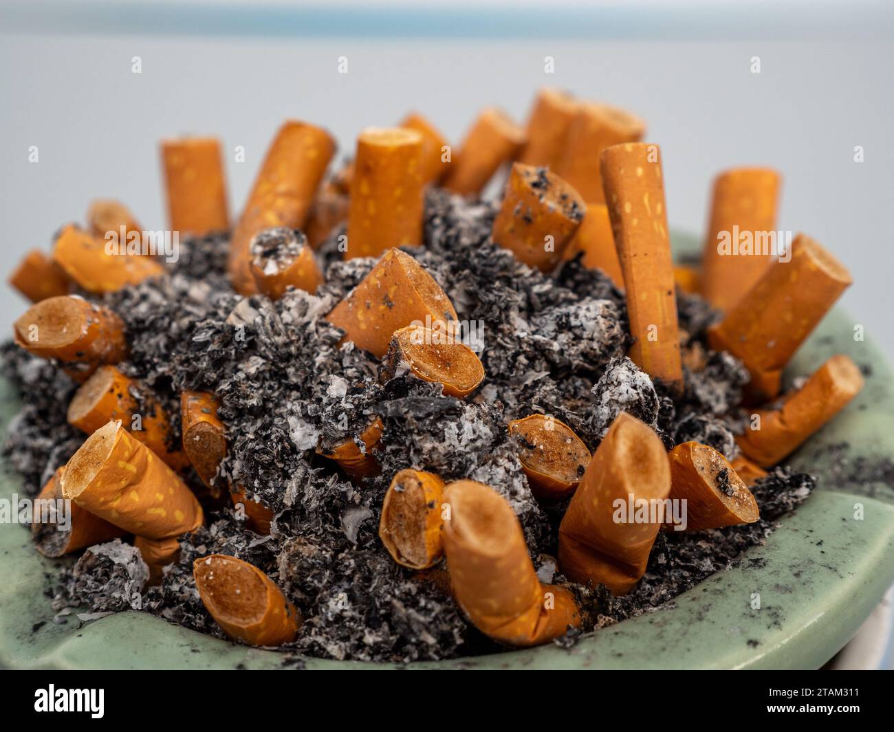 Ashtray full of cigarette butts. Ashtray with cigarette butts close-up ...