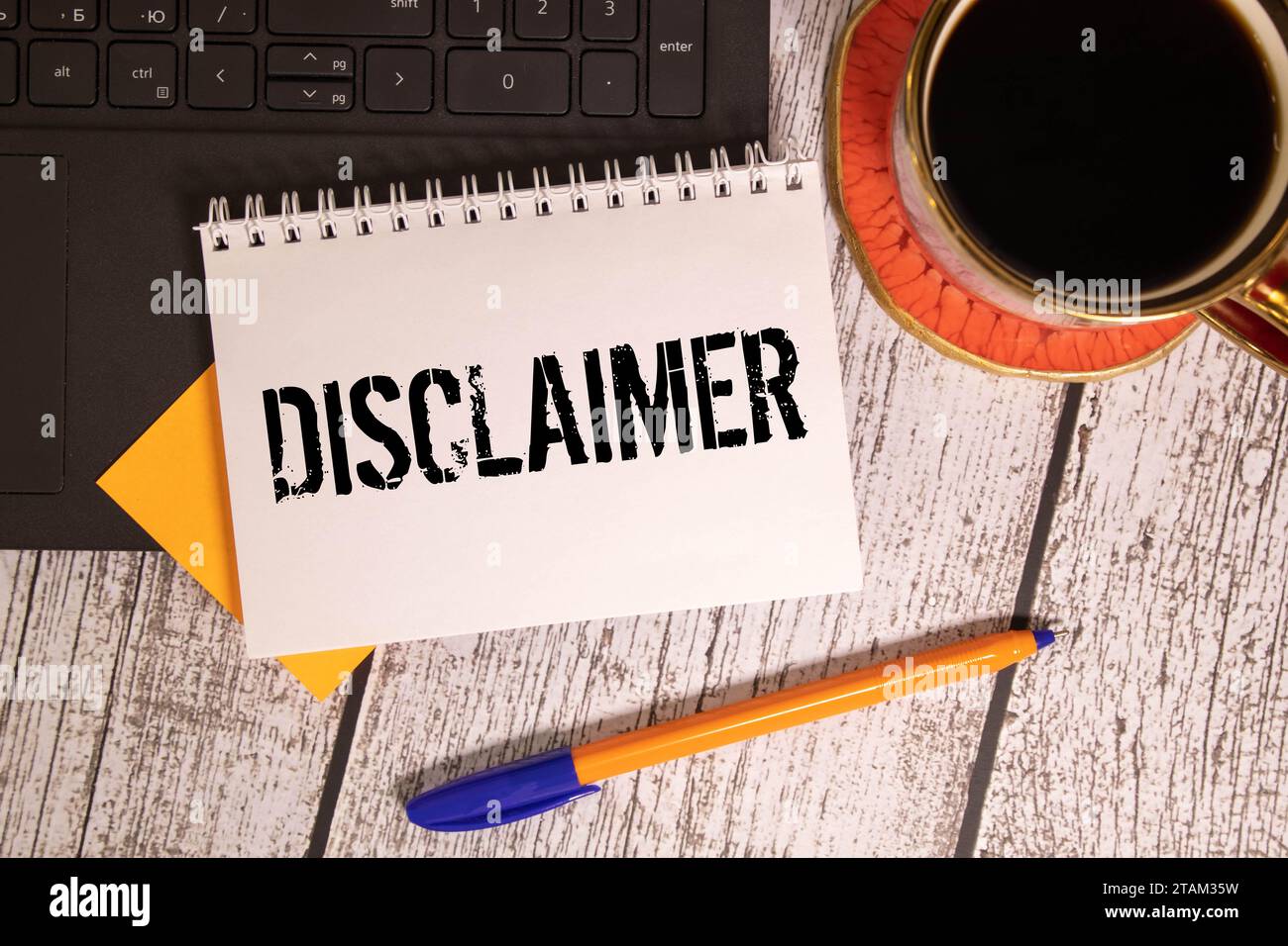 White paper with text Disclaimer lying on the keyboard Stock Photo - Alamy