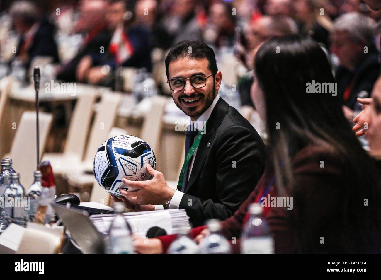 Vienna, Austria, Austria. 1st Dec, 2023. A man holds a football signed ...