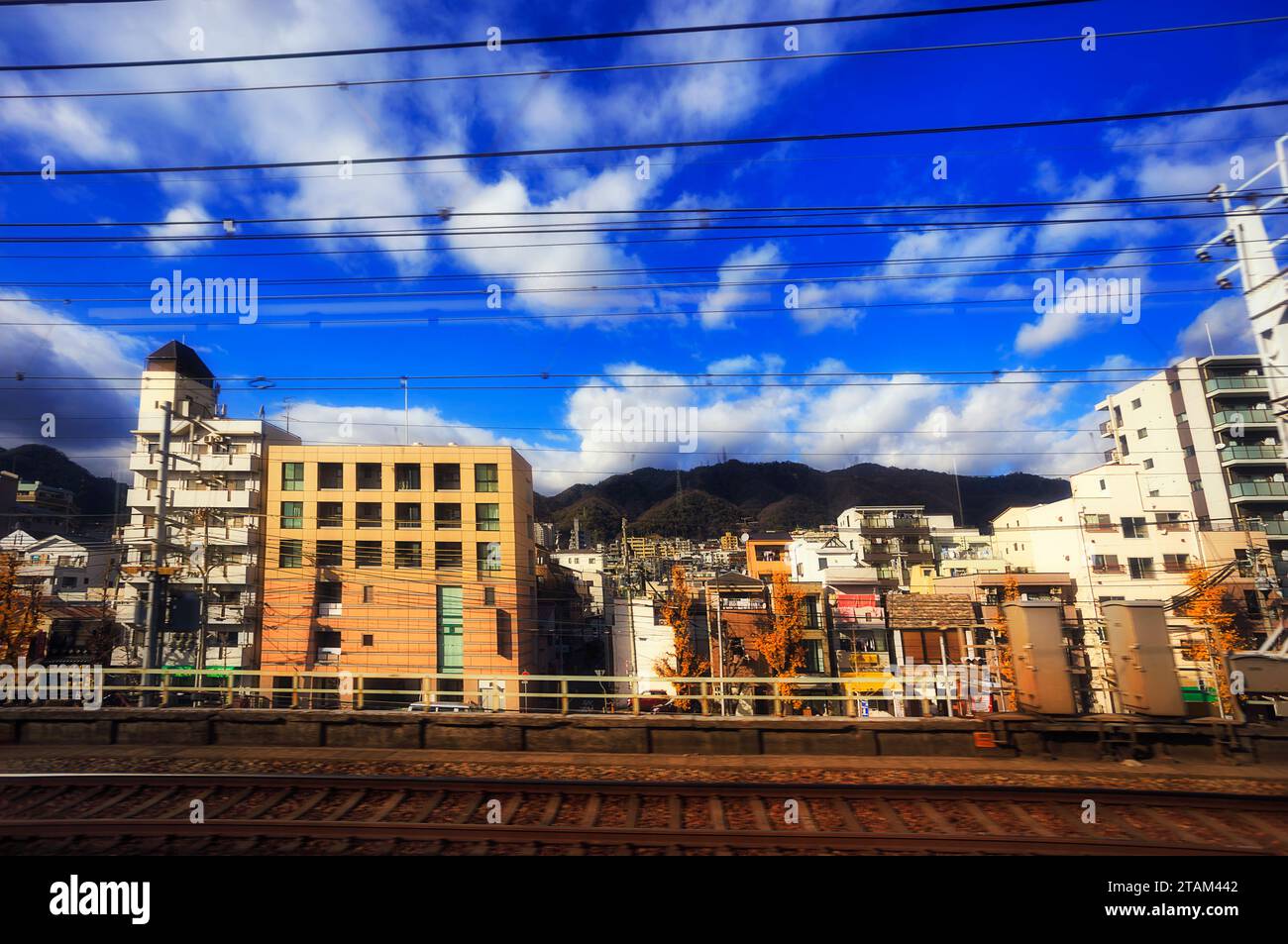 Fast moving train transiting through Japanese city on a bright sunny ...