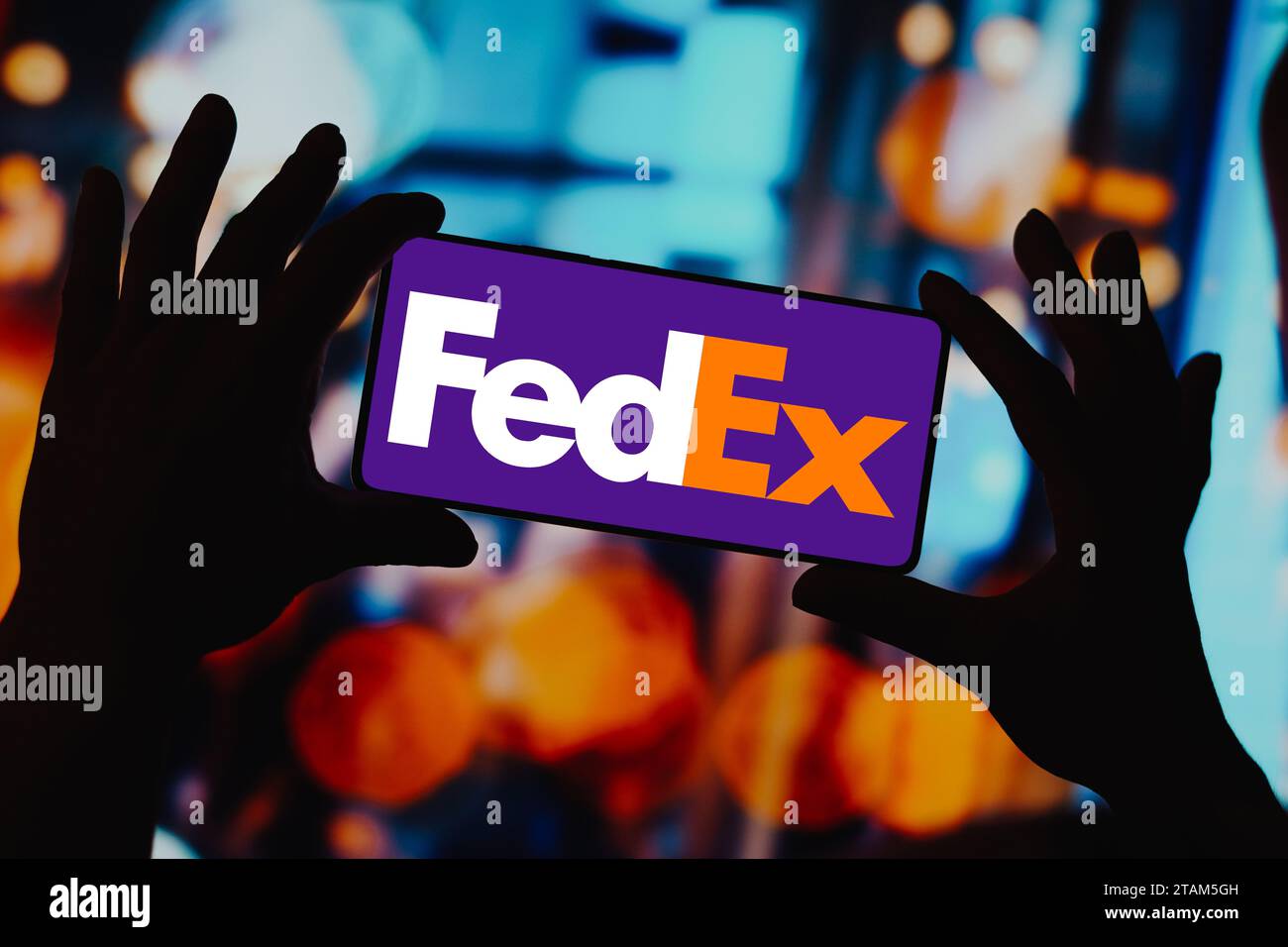 In this photo illustration, the FedEx logo is displayed on a smartphone ...