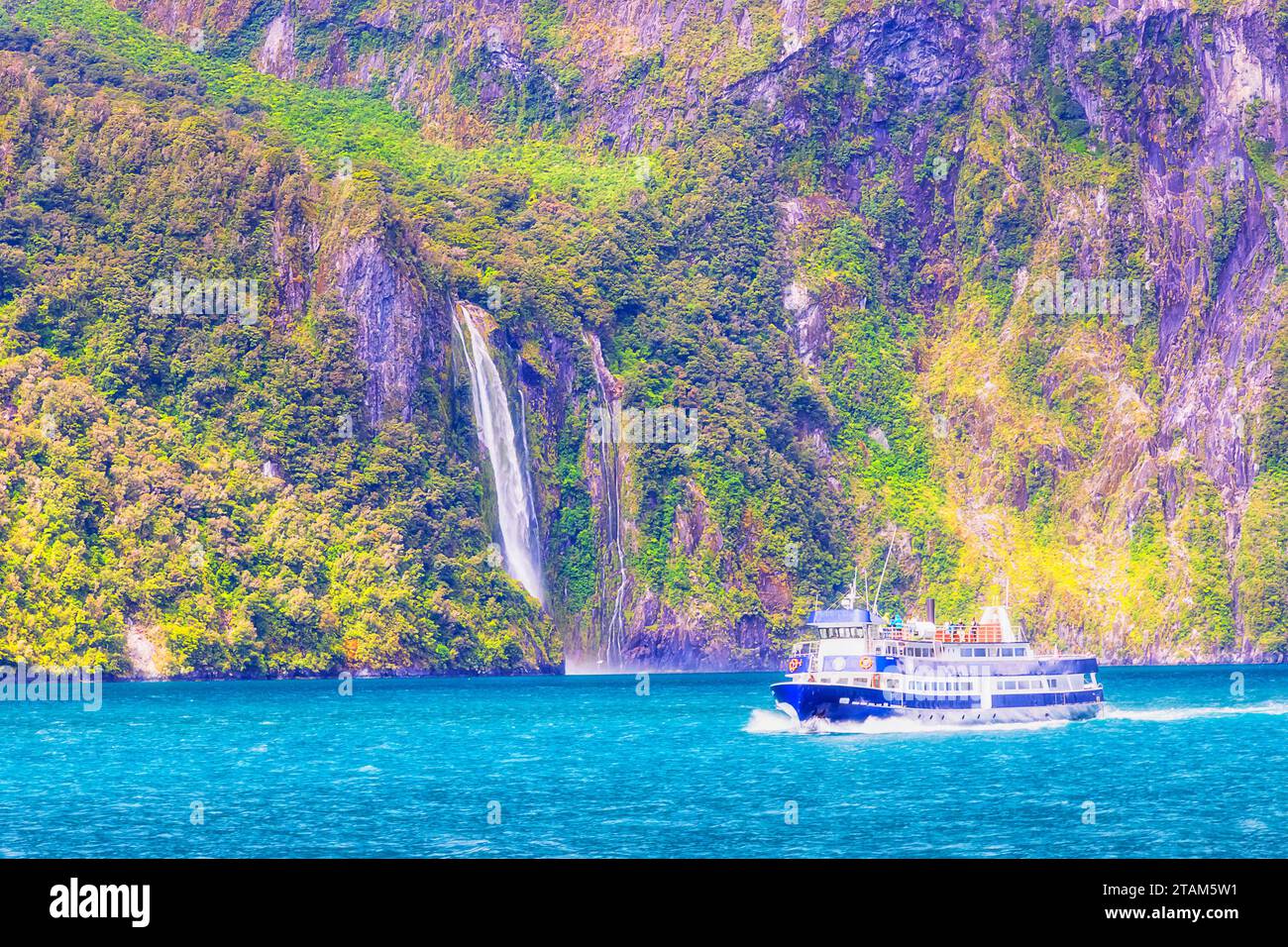 Cruise ship with tourists on board at Stirling waterfall in Milford ...