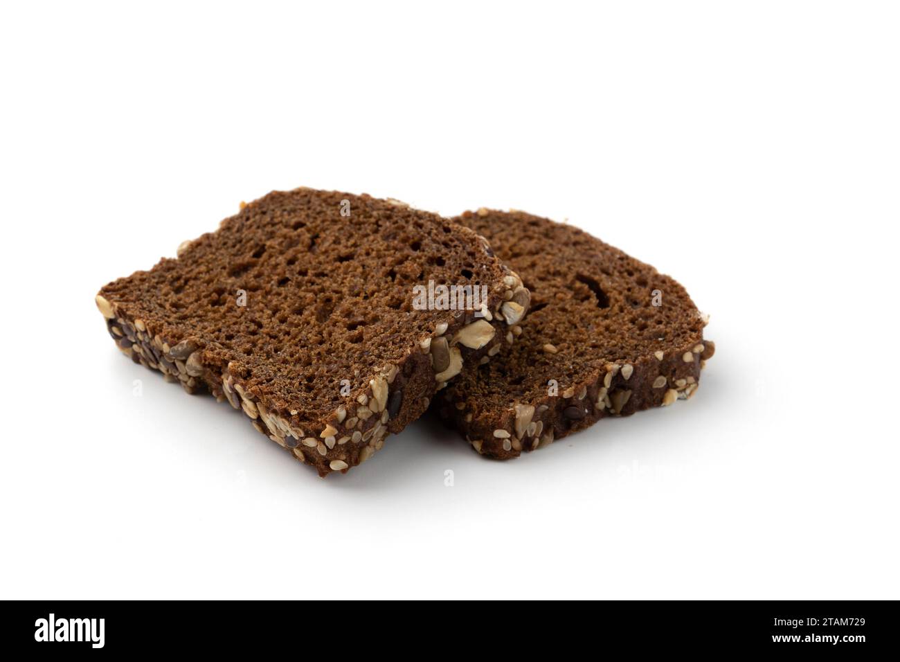 two slices of rye bread on white background, side view, heap of fresh ...