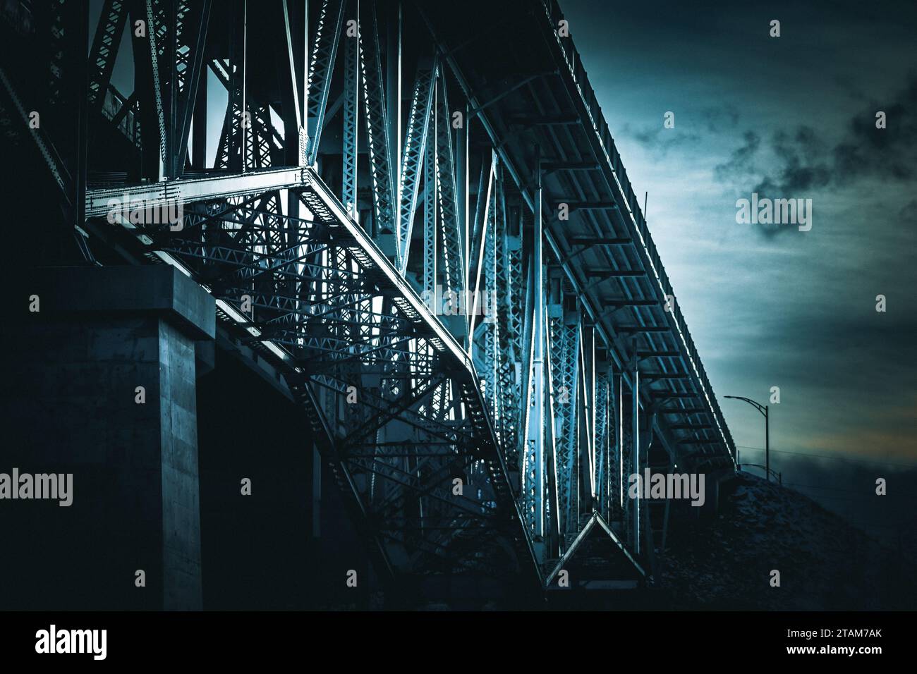 An under view of a steel bridge in a dark mood Stock Photo - Alamy