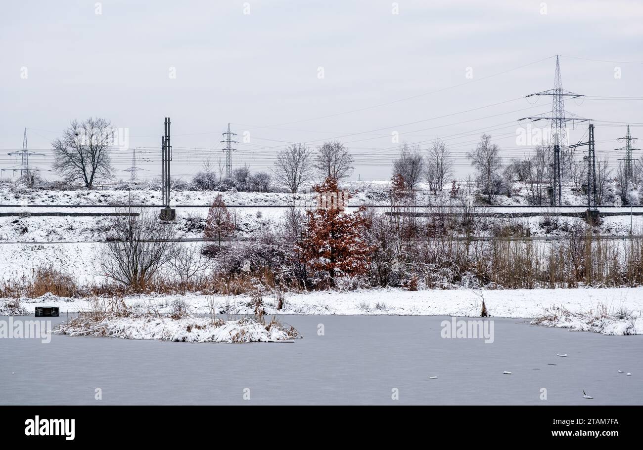 snowy urban landscape, snowy train track behind frozen lake, snow ...