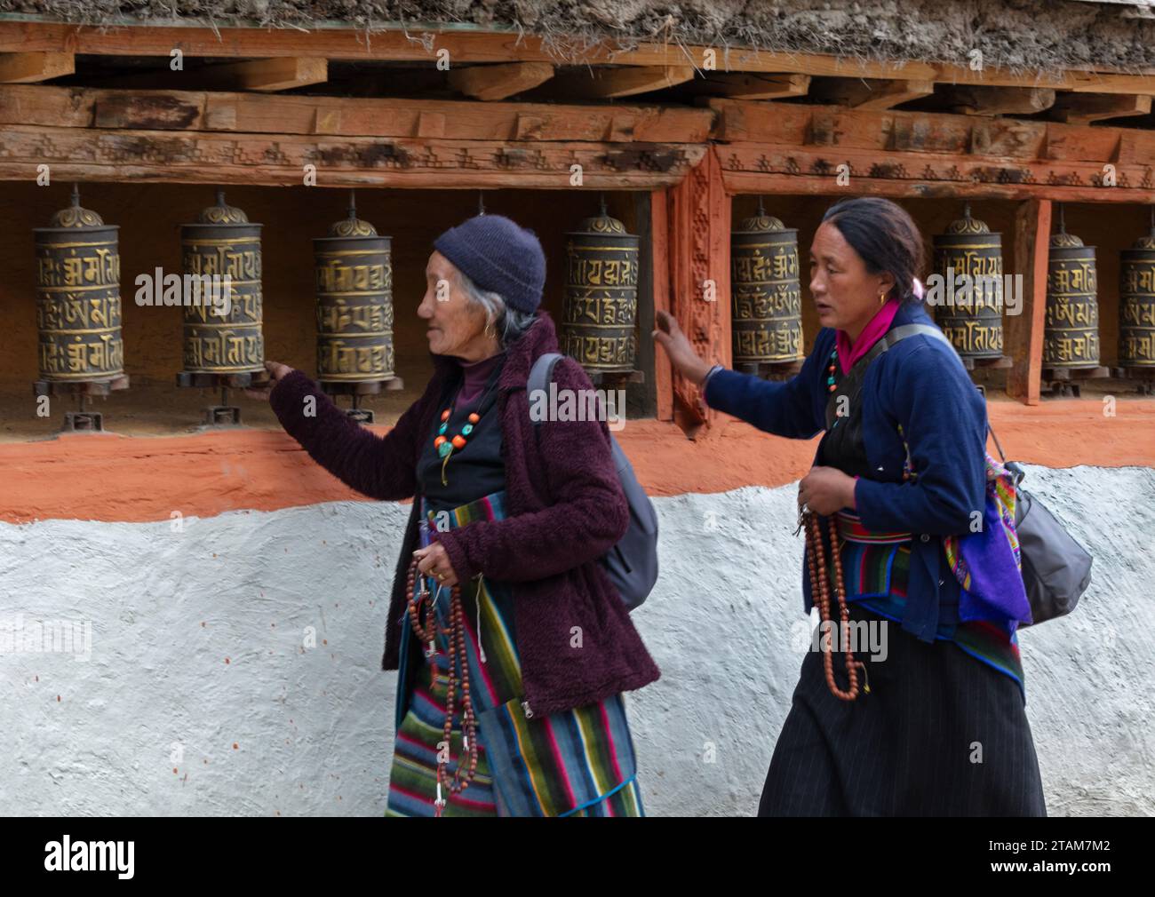 Pilgrims spin prayer wheels at Lo Gekar Monastery in Ghar village, the ...