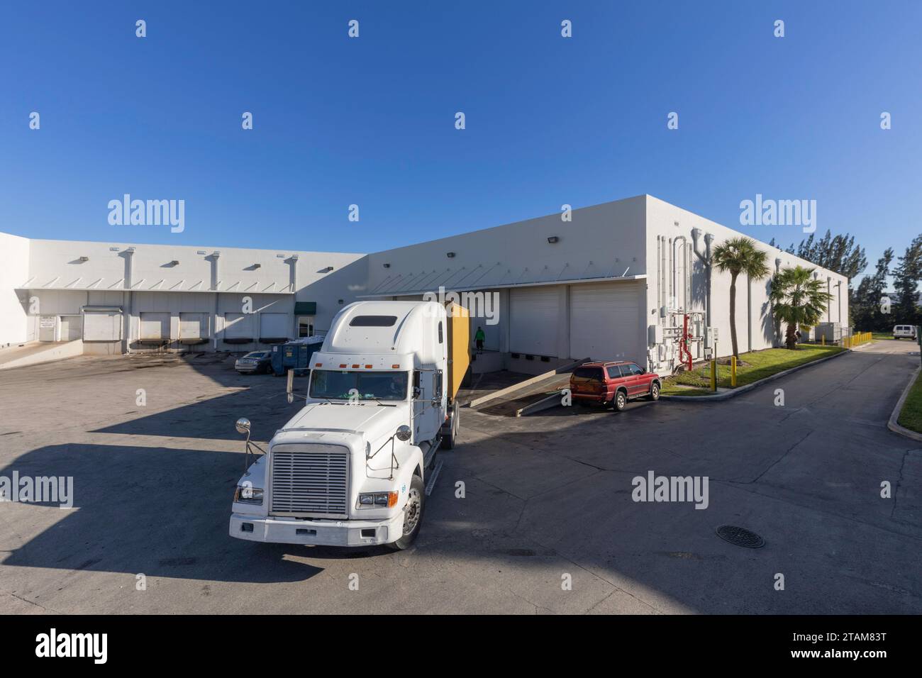 Trucks parked at warehouse loading dock area Stock Photo - Alamy