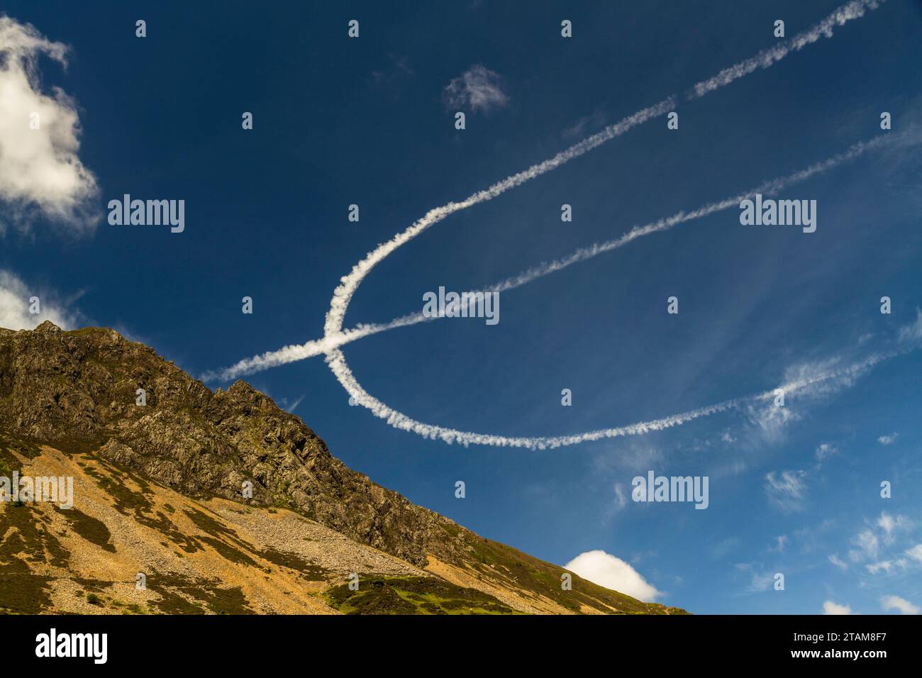 Contrails, Condensation Trails, or Vapour Trails, by mountain, crossing ...