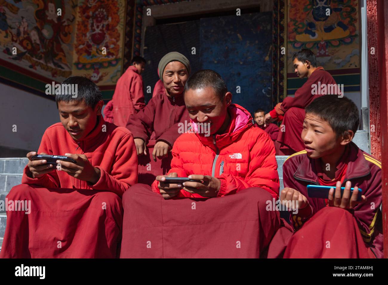 Young monks with cell phones at Chode Gonpa, the main Sakya monastery in Lo Manthang, the ...