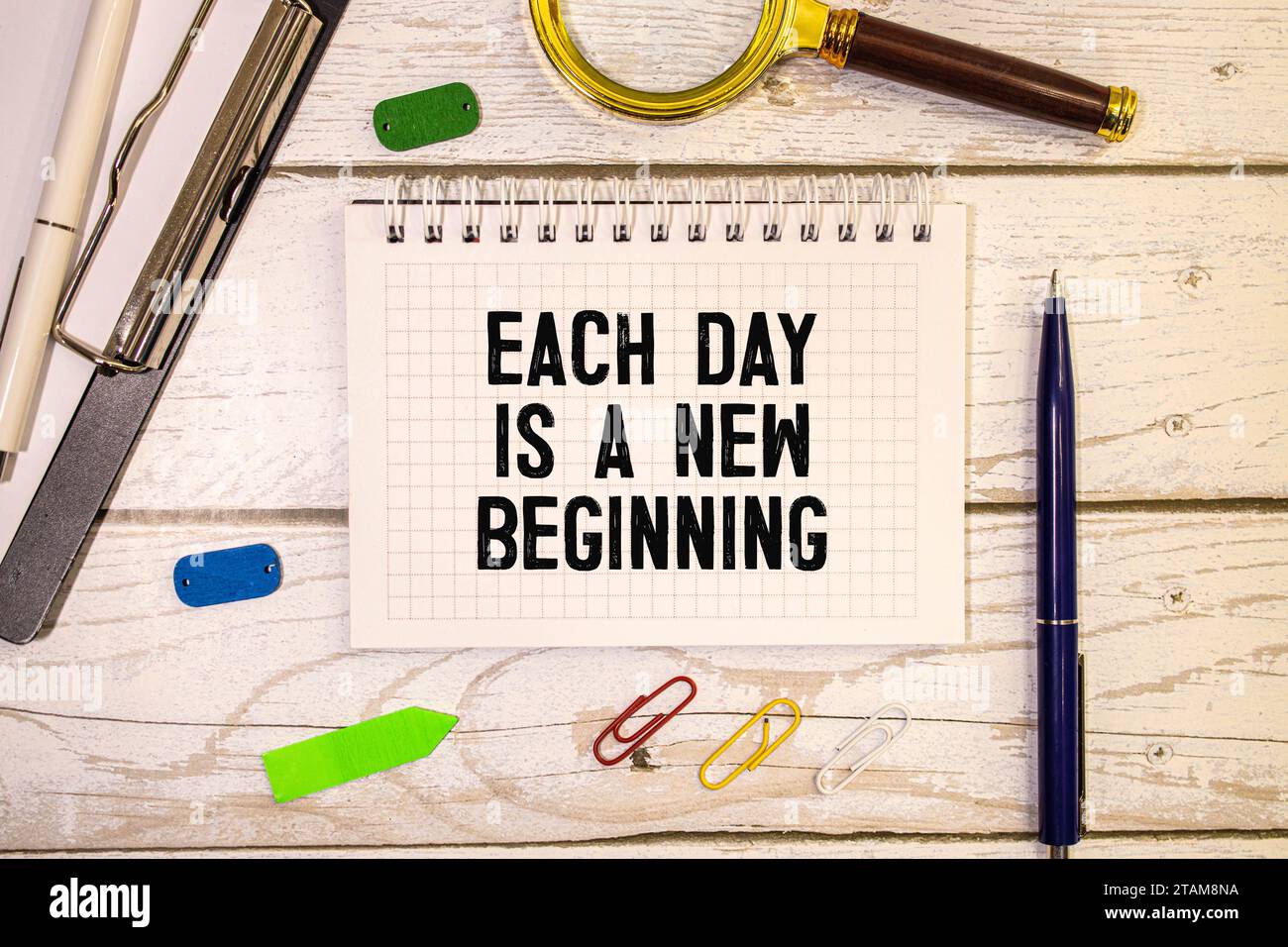 Each Day Is A New Beginning - text on a notepad with wrinkled paper and ...